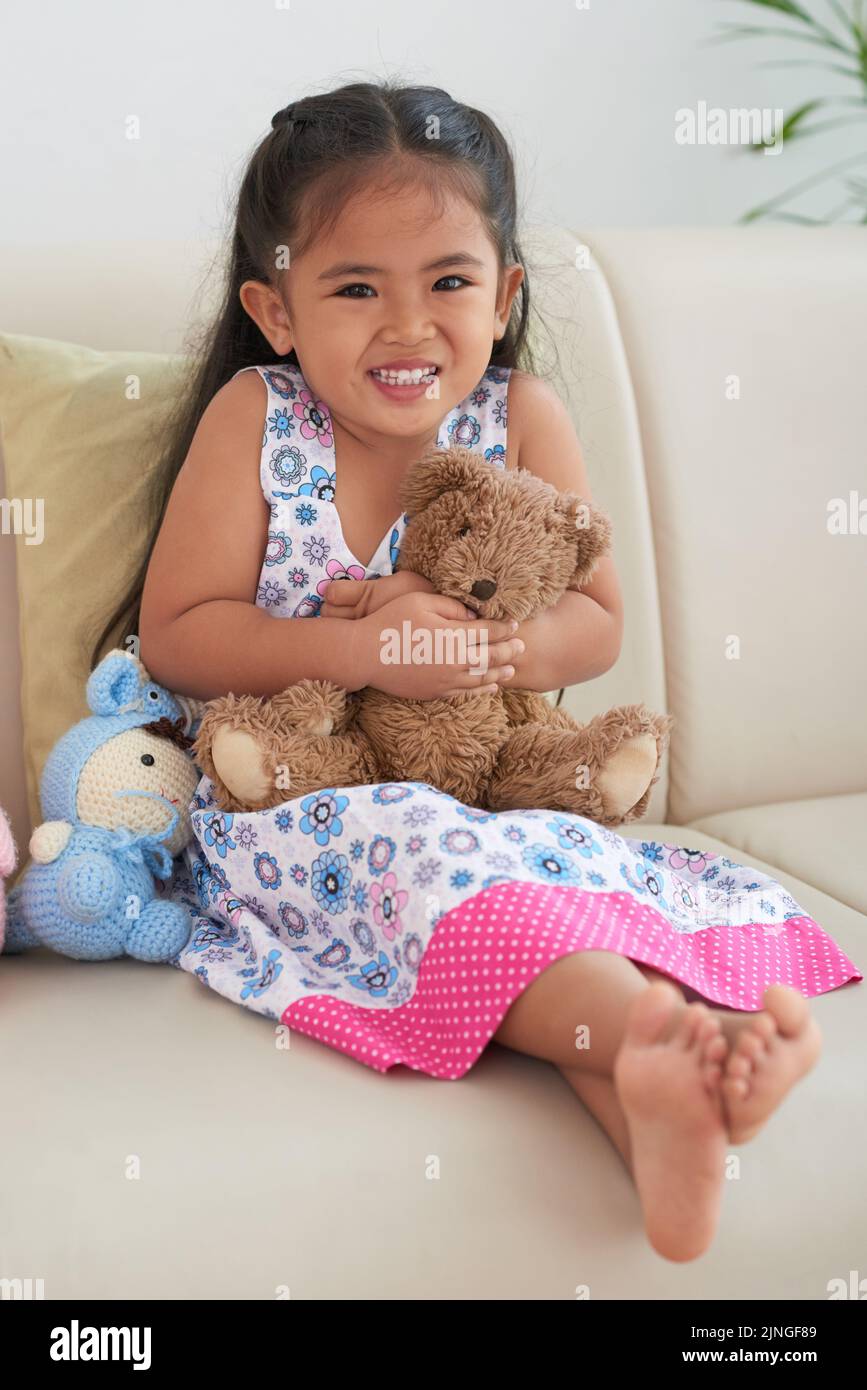 Happy adorable little girl hugging her teddy bear Stock Photo - Alamy