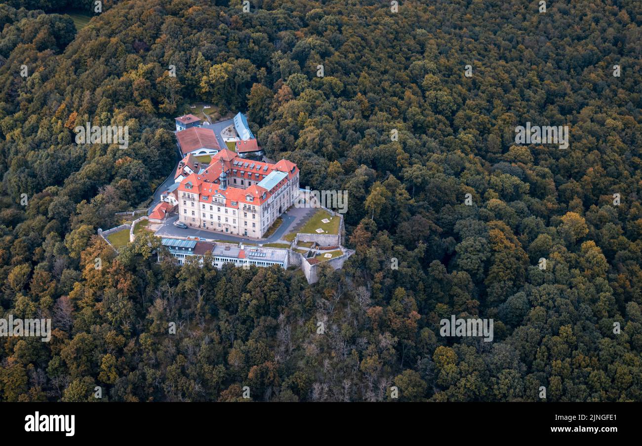 An aerial view of Bieberstein Castle on a hill in a forest in Germany ...