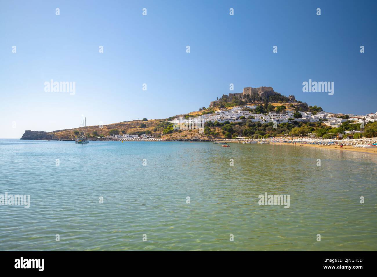 Lindos beach with the town and the Acropolis on background, Rhodes ...
