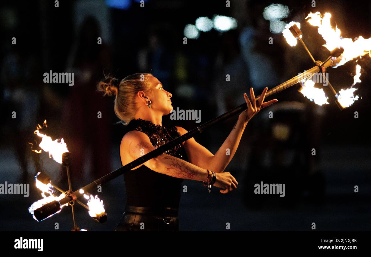A female fire juggler doing tricks in Paks, Hungary Stock Photo - Alamy