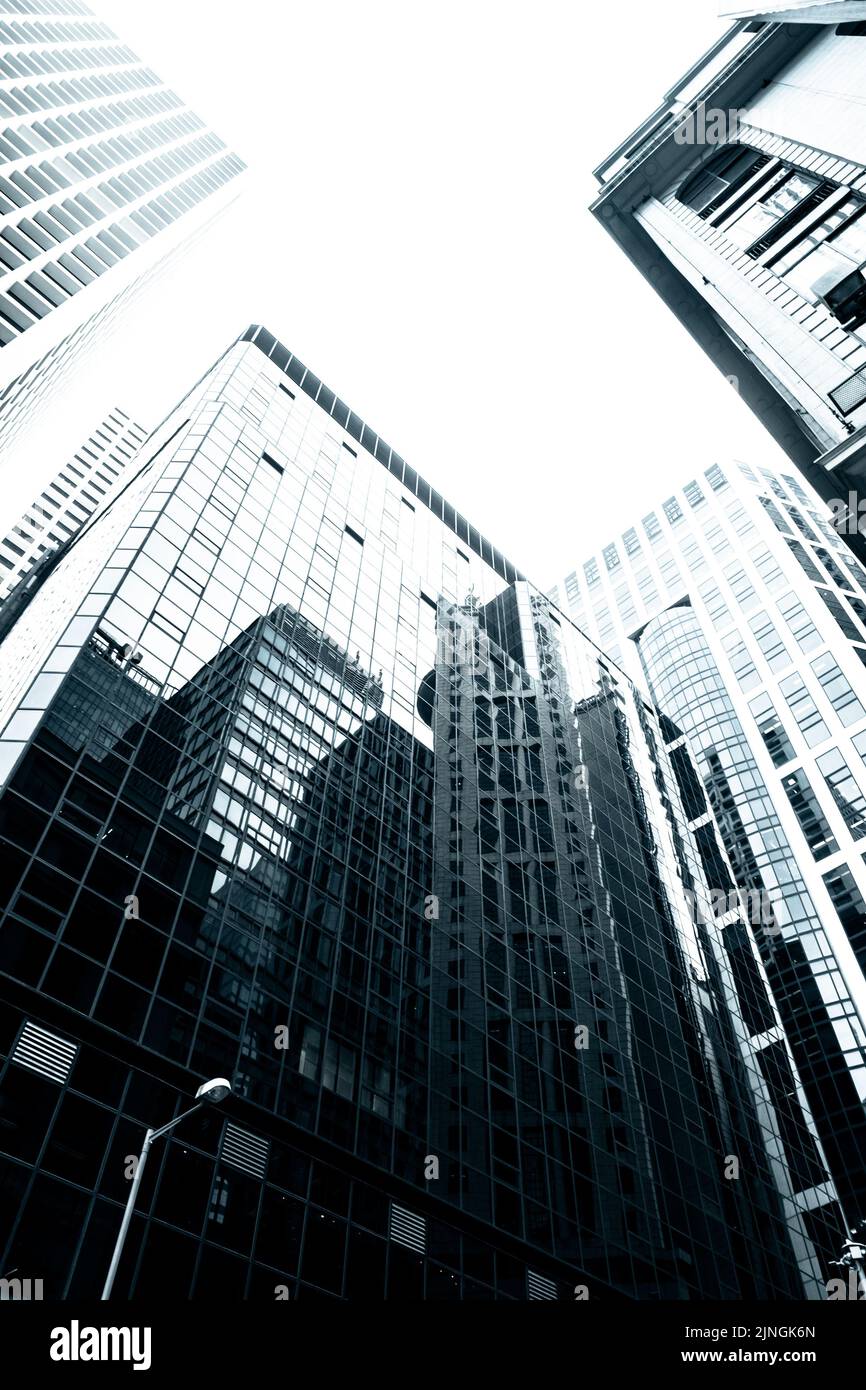 A dramatic low angle grayscale shot of a high rise office block in Hong ...