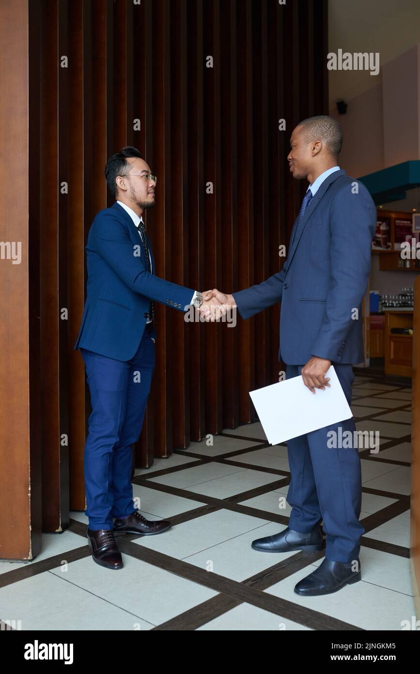 Multi-ethnic business people shaking hands to greet each others Stock ...