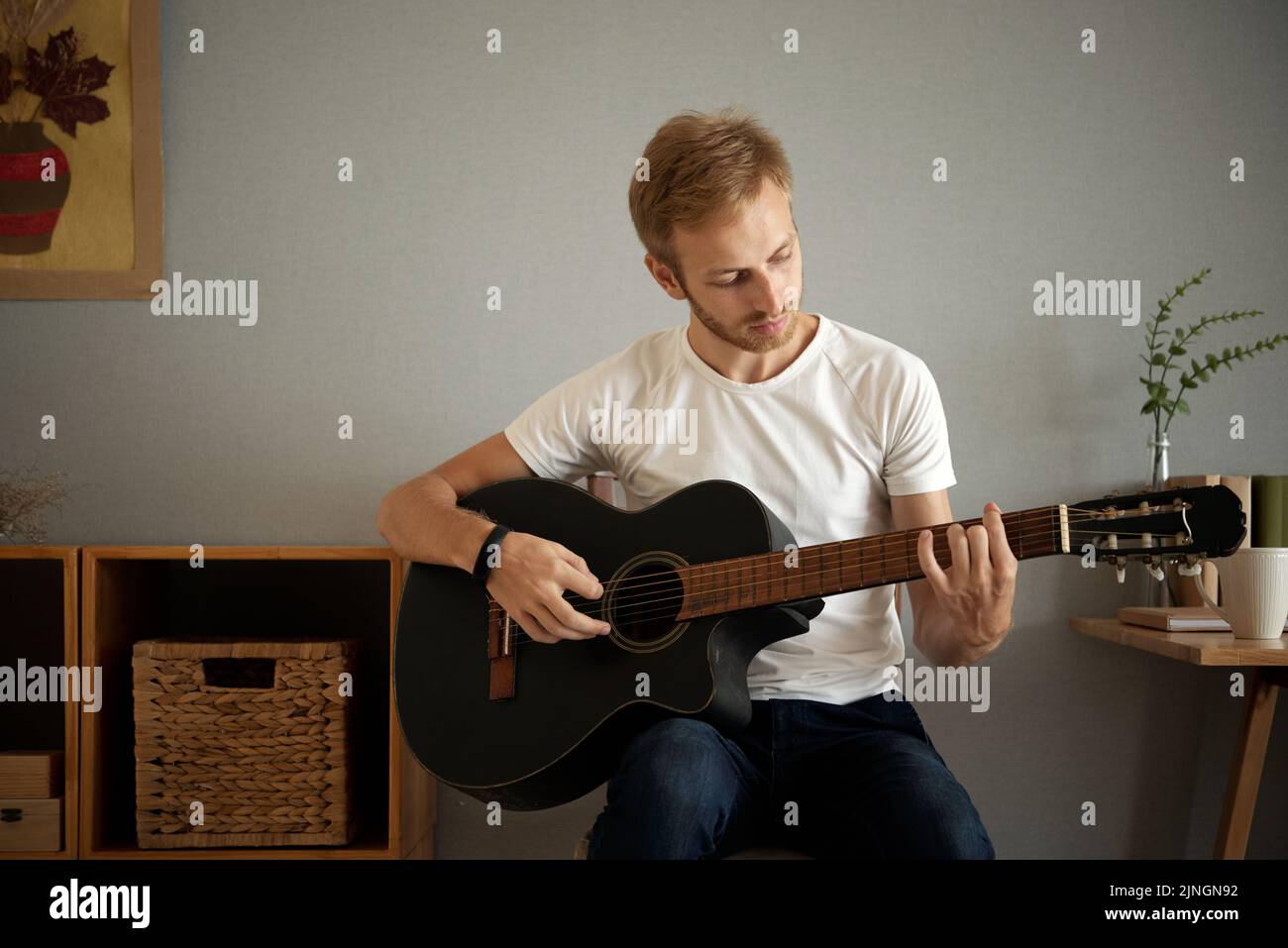 Young guy playing guitar home hi-res stock photography and images - Alamy