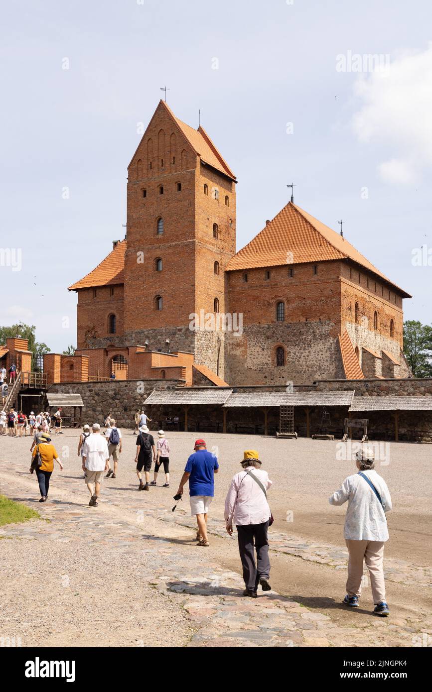 Lithuania tourism; tourists at Trakai Castle on Trakai island, a ...