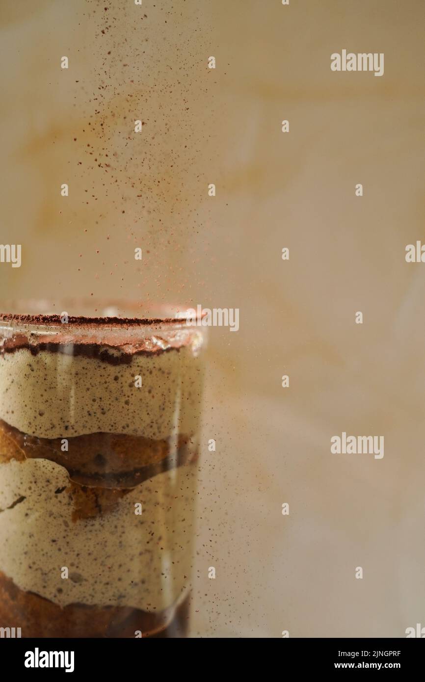 Italian dessert Tiramisu with chocolate powder Stock Photo - Alamy