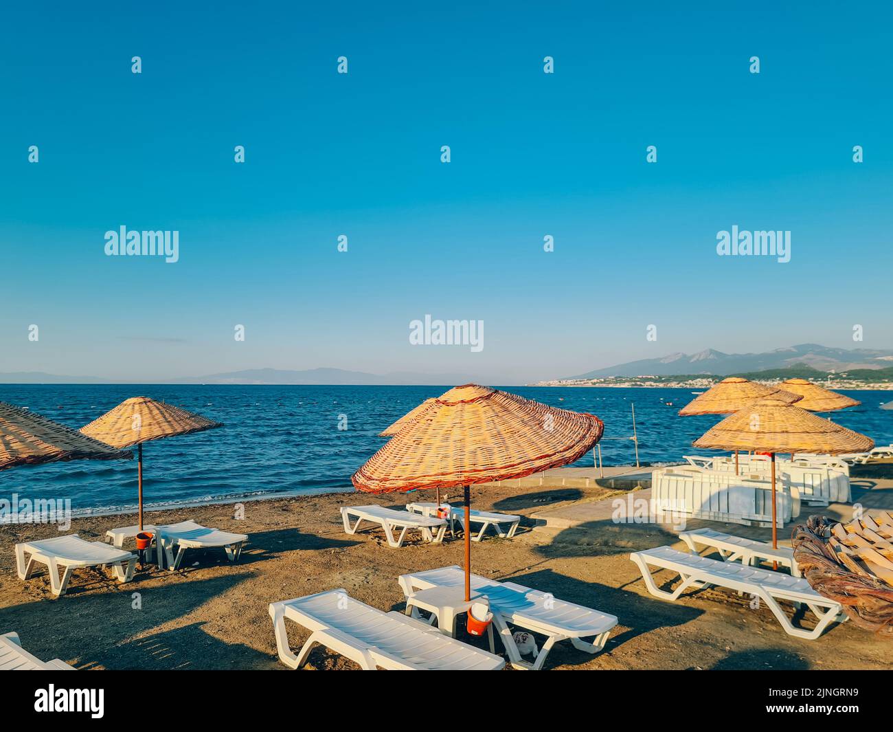 Bamboo beach umbrella on blue sky background Stock Photo - Alamy