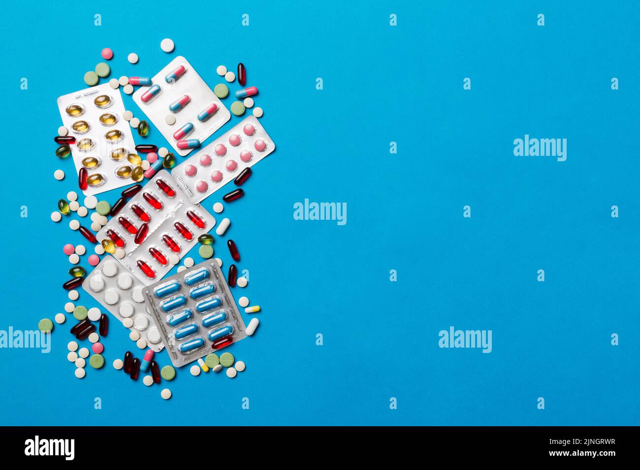 Protective face masks or surgical masks, medicine pills and thermometer ...