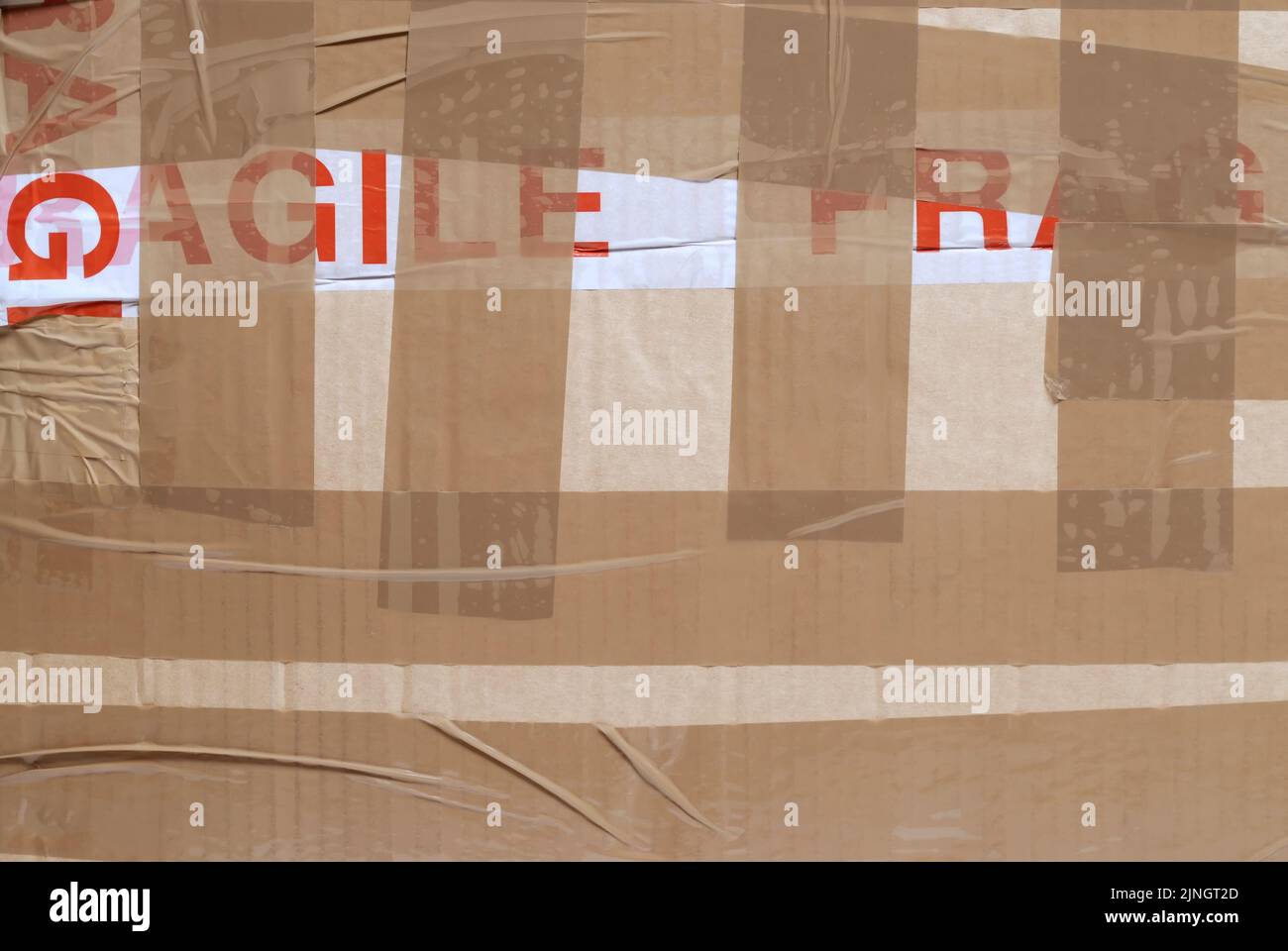 Close up of packaging brown tape and fragile tape on cardboard box Stock Photo - Alamy