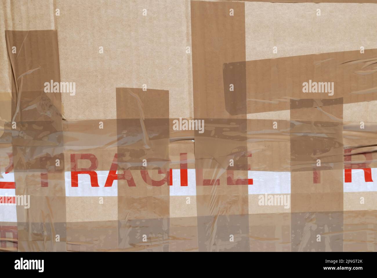 Close up of packaging brown tape and fragile tape on cardboard box ...