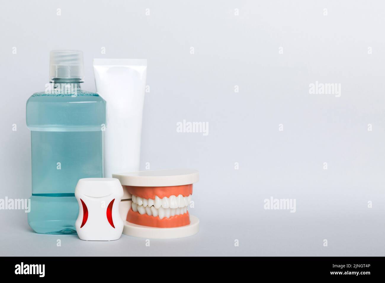 Mouthwash and other oral hygiene products on colored table top view ...