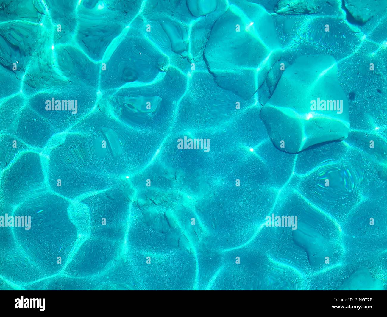 Turquoise surface of transparent sea water with sun glints Stock Photo ...