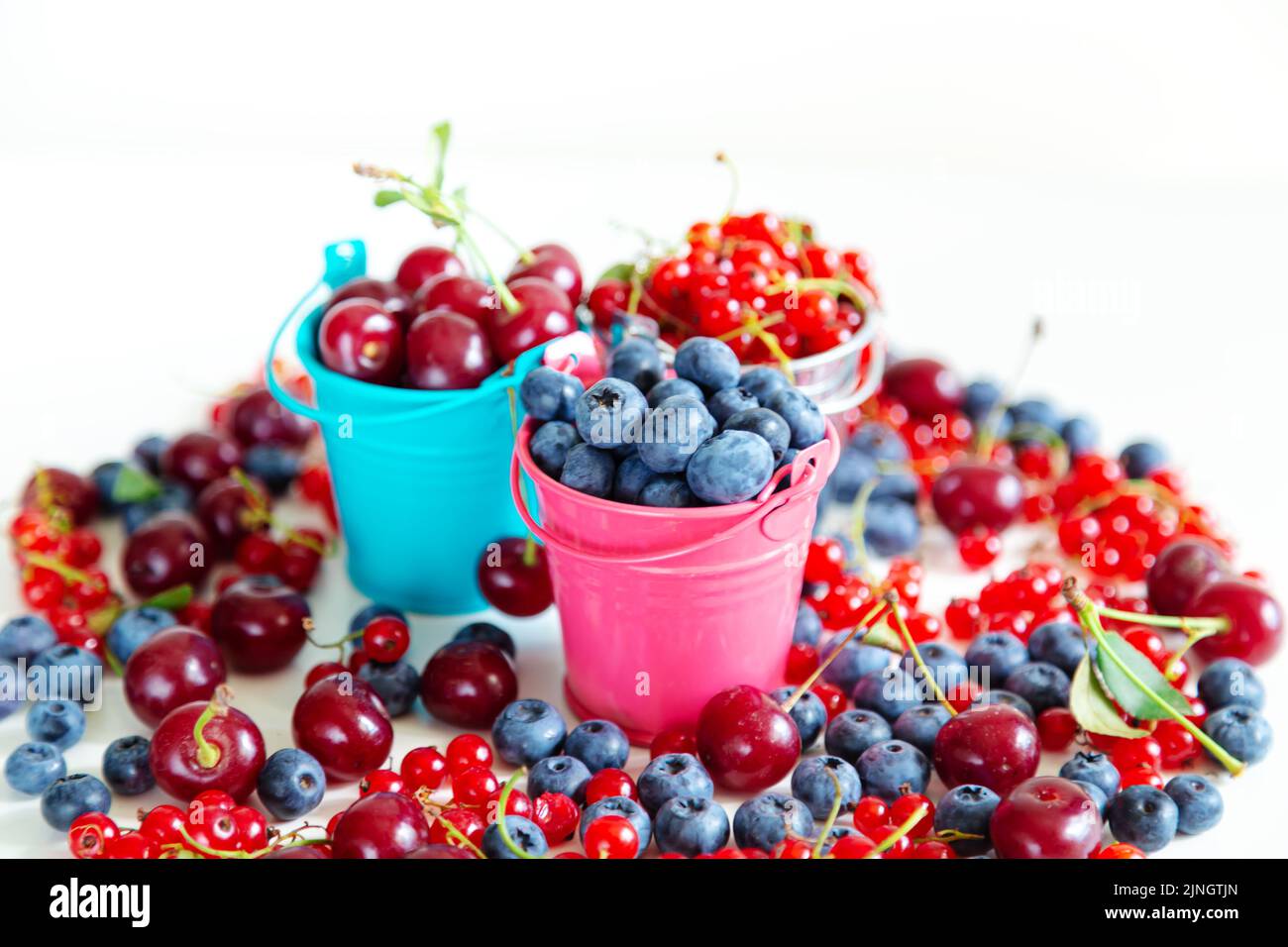 Mix of fresh berries in small buckets. Juicy summer wallpaper. White ...