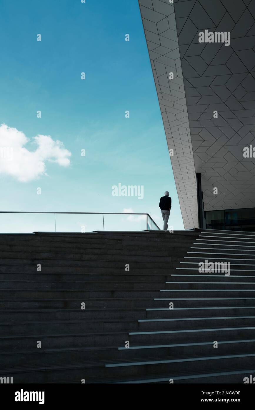 A man walking between the lines of geometry Stock Photo - Alamy
