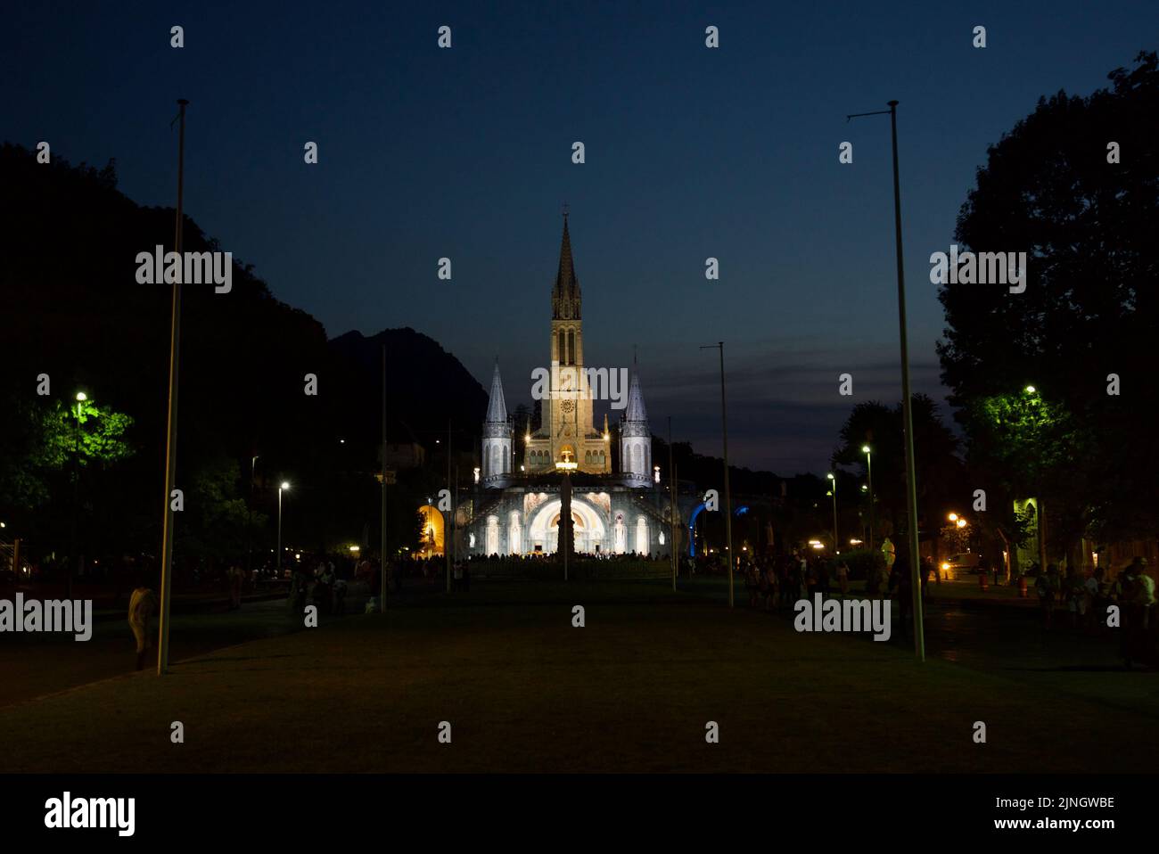 People gathered at Sanctuaires Notre-Dame de Lourdes, at night. A ...