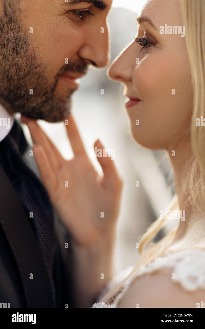 Side view of loving happy wedding couple meeting eyes. Young woman ...