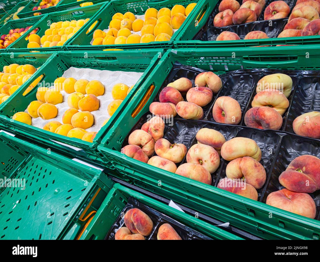 Organized orange and yellow peaches in the supermarket. Fruit and ...