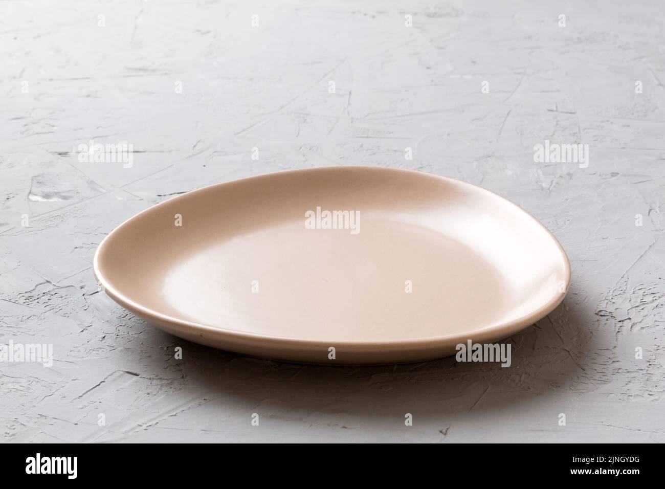 Perspective view of empty pink plate on cement background. Empty space ...