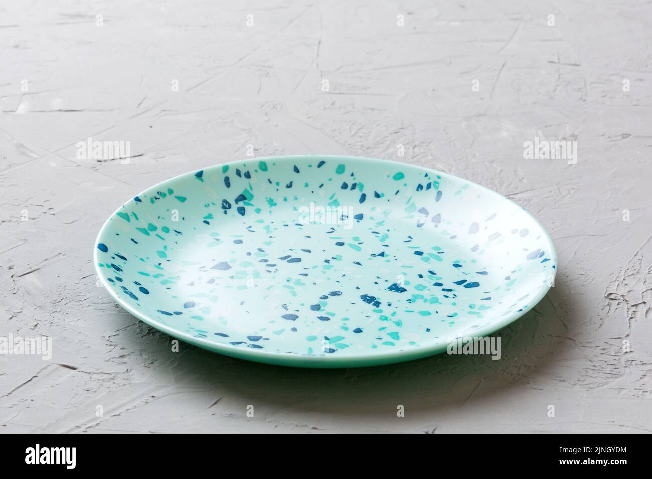 Perspective view of empty blue plate on cement background. Empty space ...