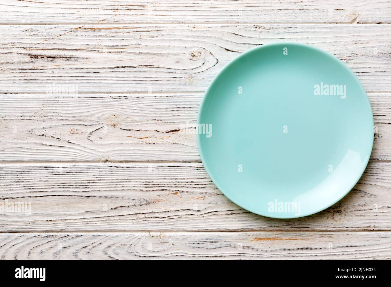 Top view of empty blue plate on wooden background. Empty space for your ...