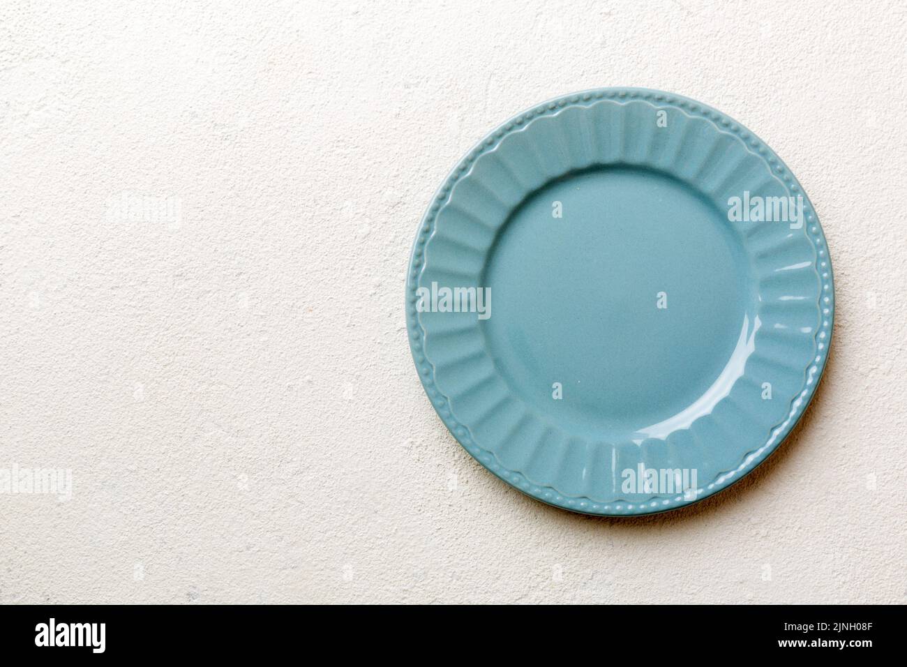 Top view of empty light plate on wooden background. Empty space for ...