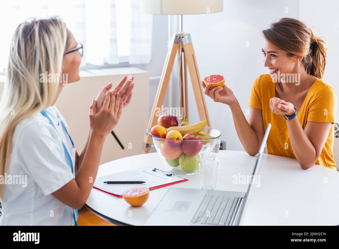 Professional nutritionist meeting a patient in the office and healthy ...