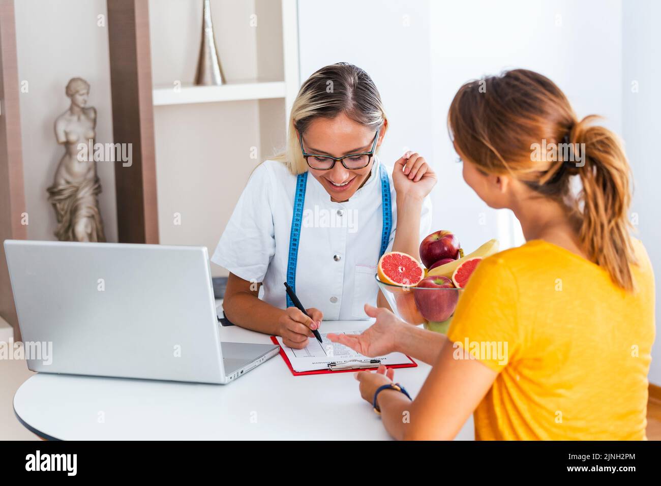 Professional nutritionist meeting a patient in the office and healthy ...