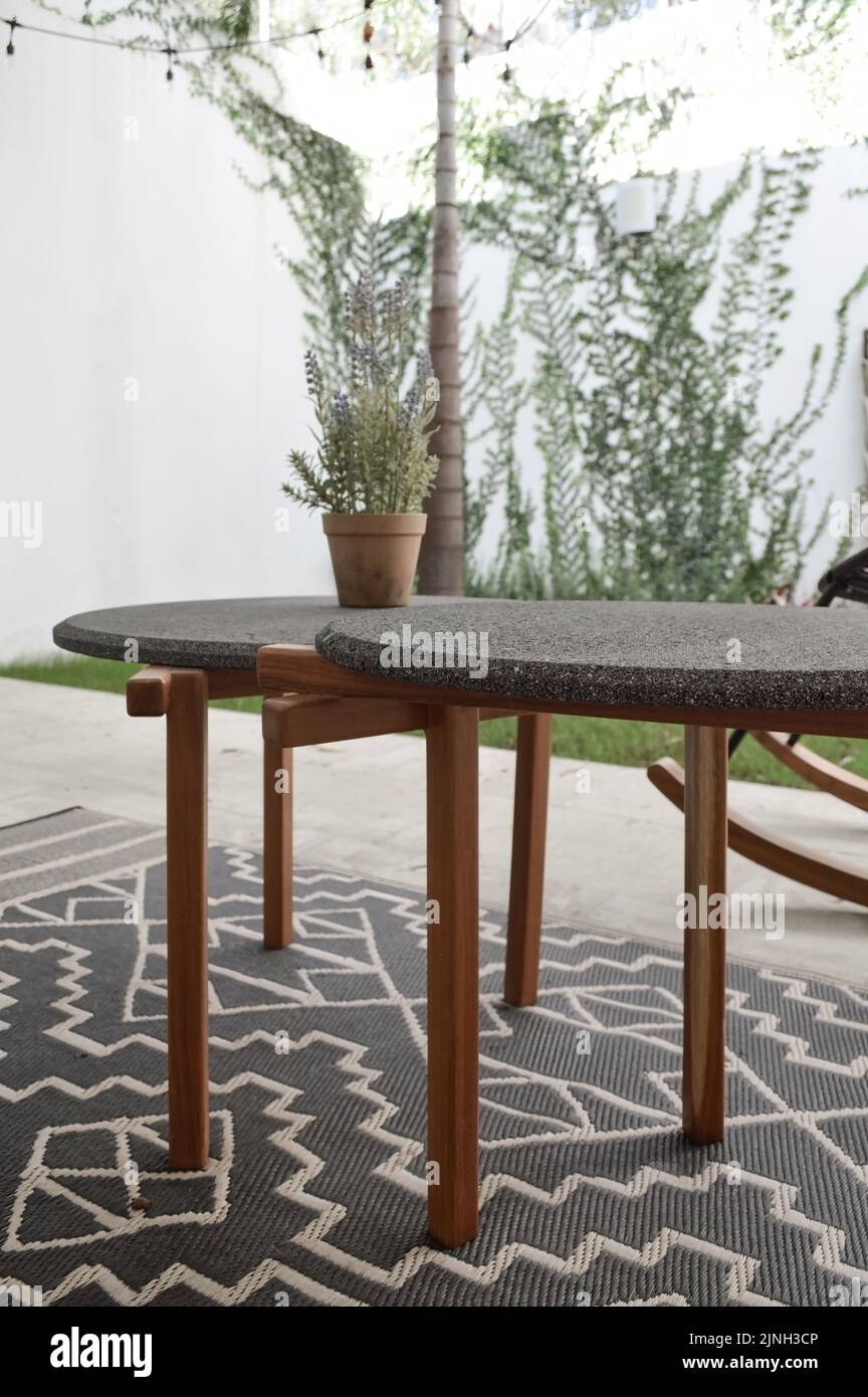 A vertical shot of a side coffee table with volcanic stone and wooden ...