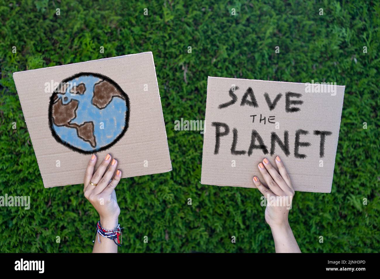 Activist with " Save the planet" placard at climate change prostest ...