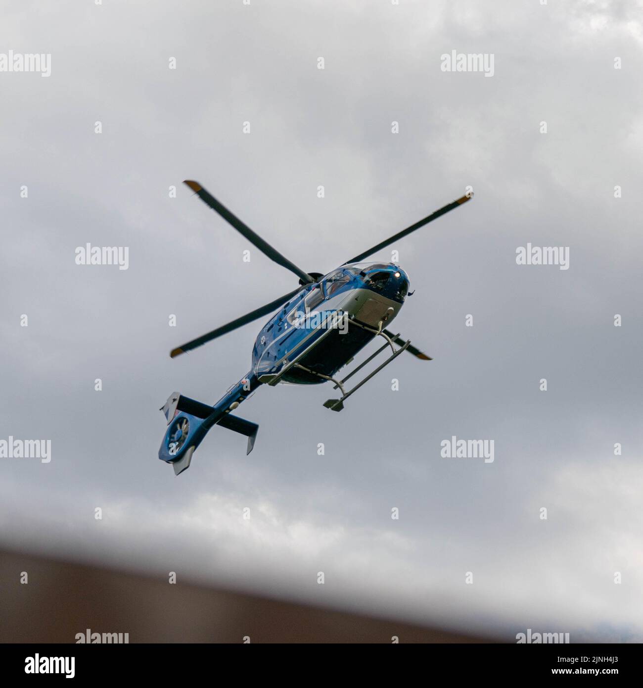 A low angle shot of the Czech republic EMS helicopter against a cloudy ...