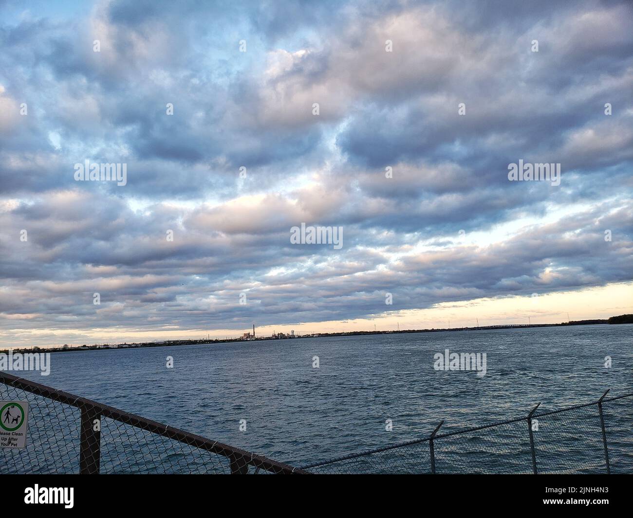 The beautiful sunset sky with fluffy clouds over Niagara River in ...