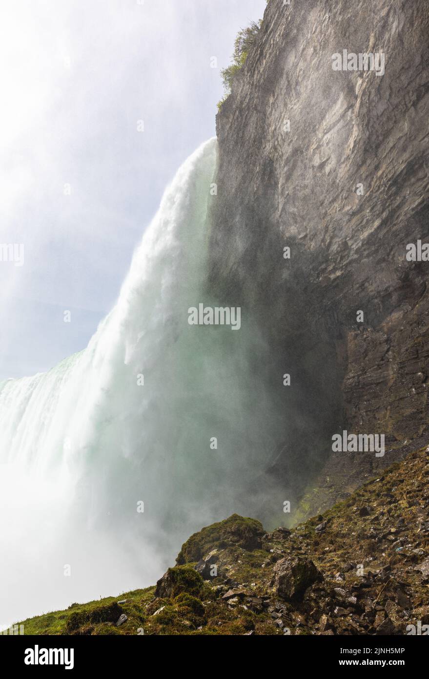 A vertical low angle shot of breathtaking Niagara Falls between United ...