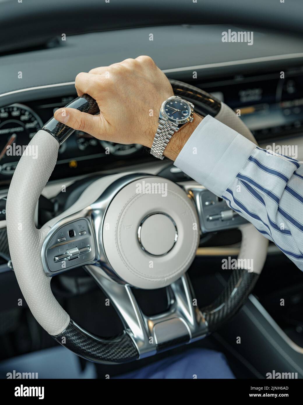 Close up view of male hand holding steering wheel of a luxury car Stock ...