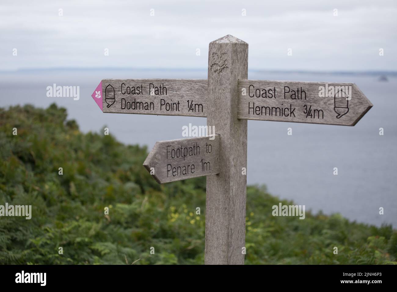 South West Coast Path signpost in Cornwall with Sea and Trees in the ...