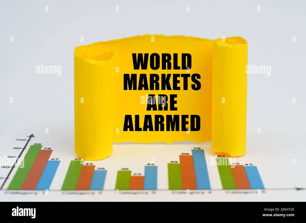 Business concept. Against the background of the graphs, a yellow paper ...