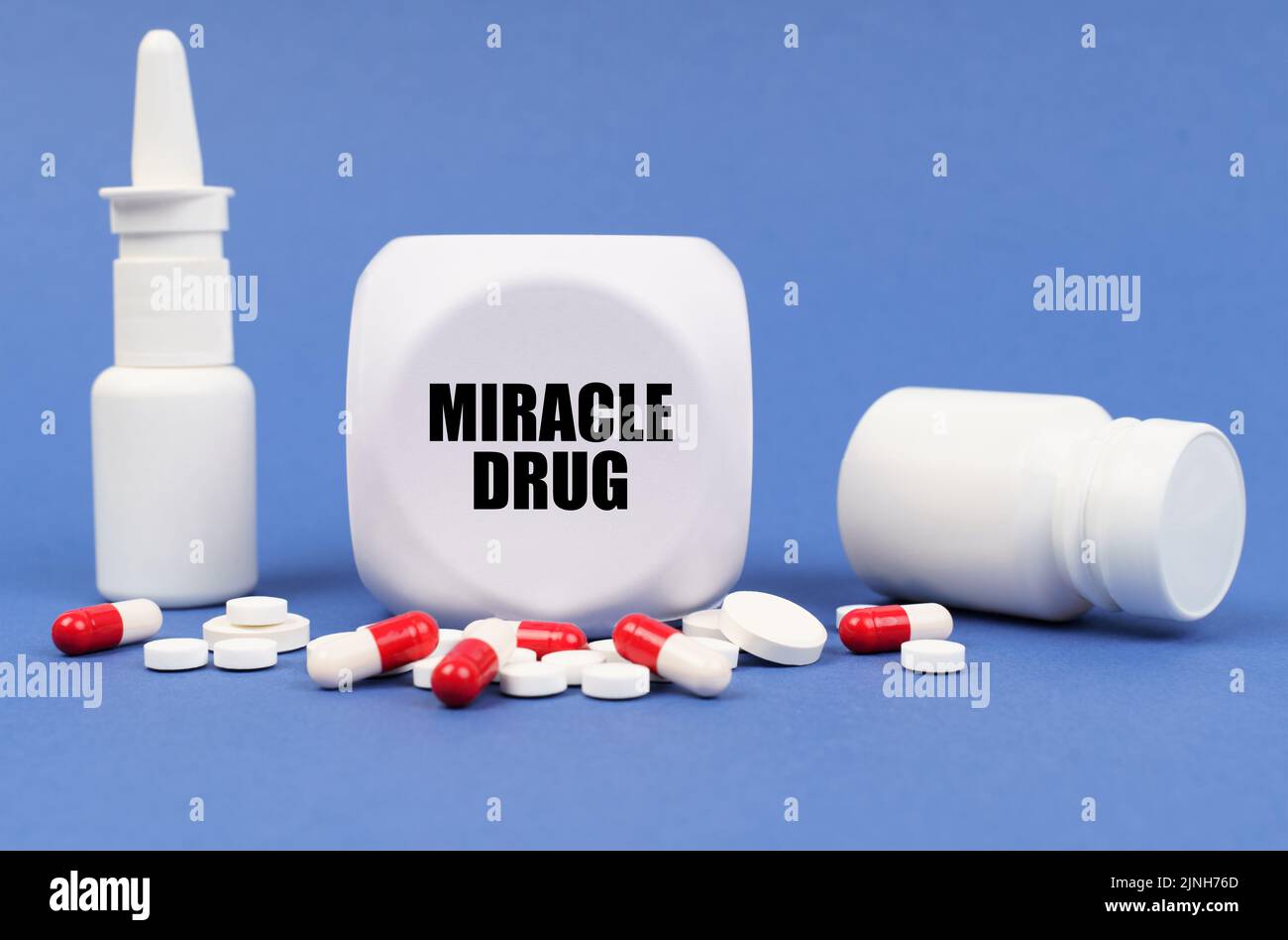 Medical concept. On the blue surface of the pill, capsule, spray, jar ...