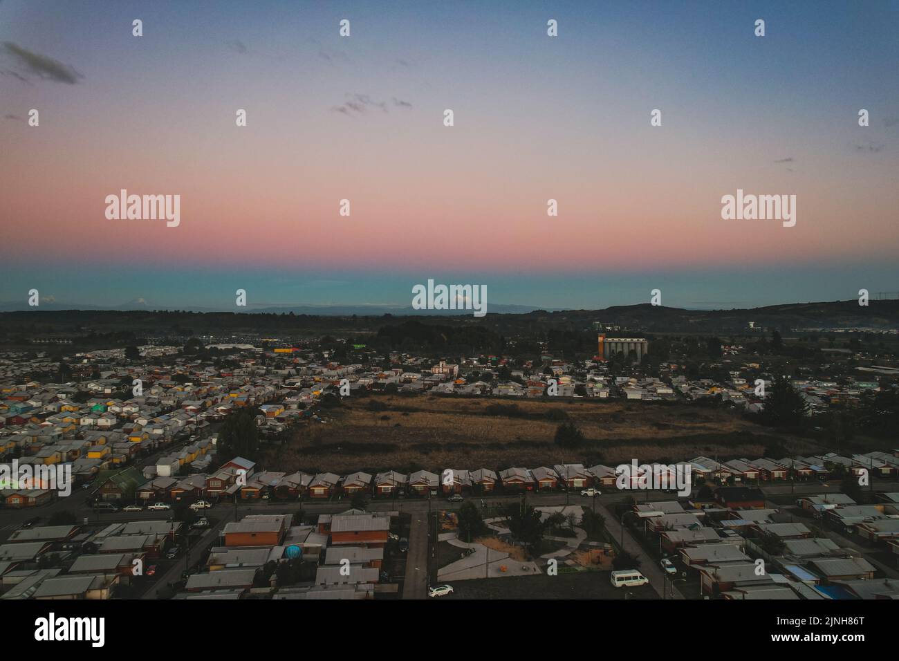 A beautiful pink sunset over a city Stock Photo - Alamy