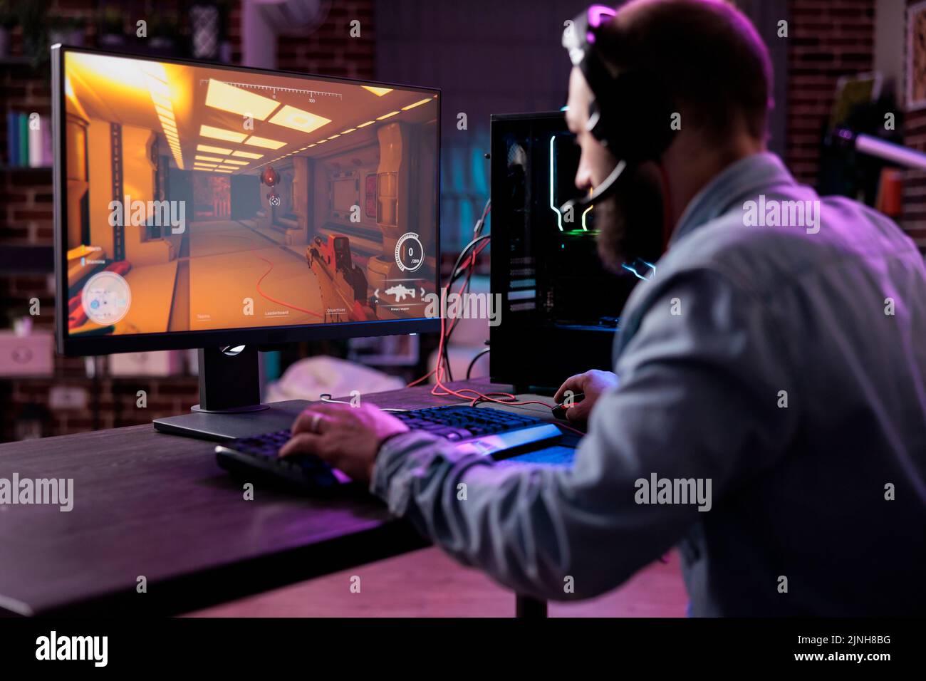 Male streamer playing online video games on computer, having fun with ...