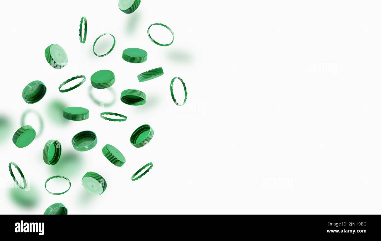 Green bottle caps for recycling on a gray background. Plastic caps ...