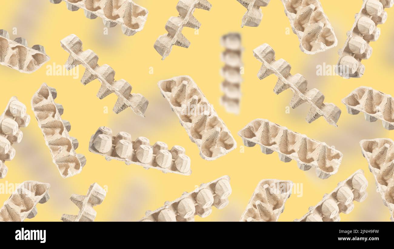 An egg carton made of recycled cardboard on a yellow background. An egg ...