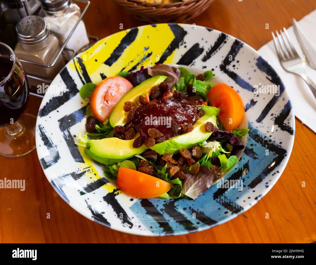 Fresh salad with avocado, raisins and strawberry jam Stock Photo - Alamy