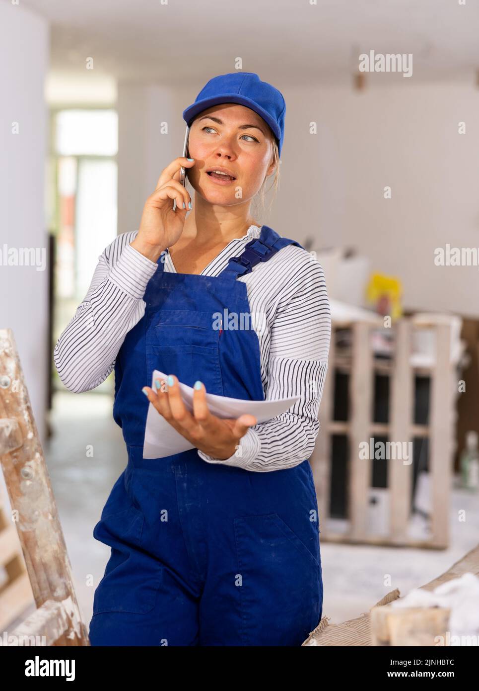 Woman builder having telephone conversation in construction site Stock ...