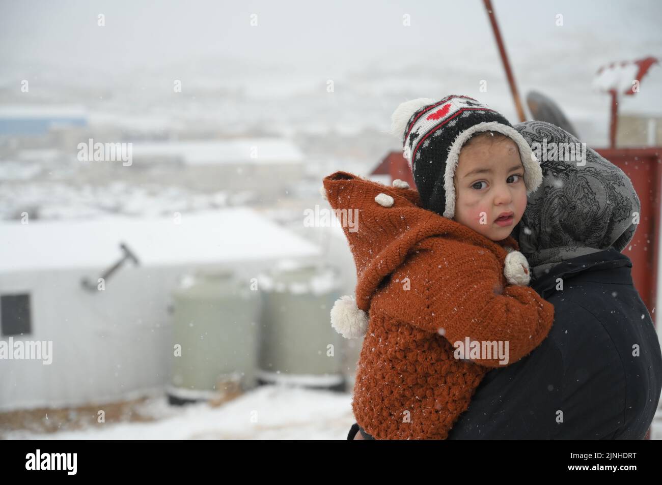 A little child of a refugee in the camp on a cold winter day in Ersal ...