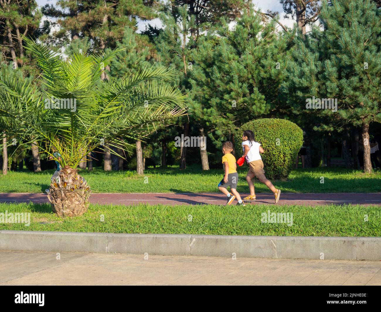 Batumi, Georgia. 07.29.2022 Running children in the park. Fun. Children ...