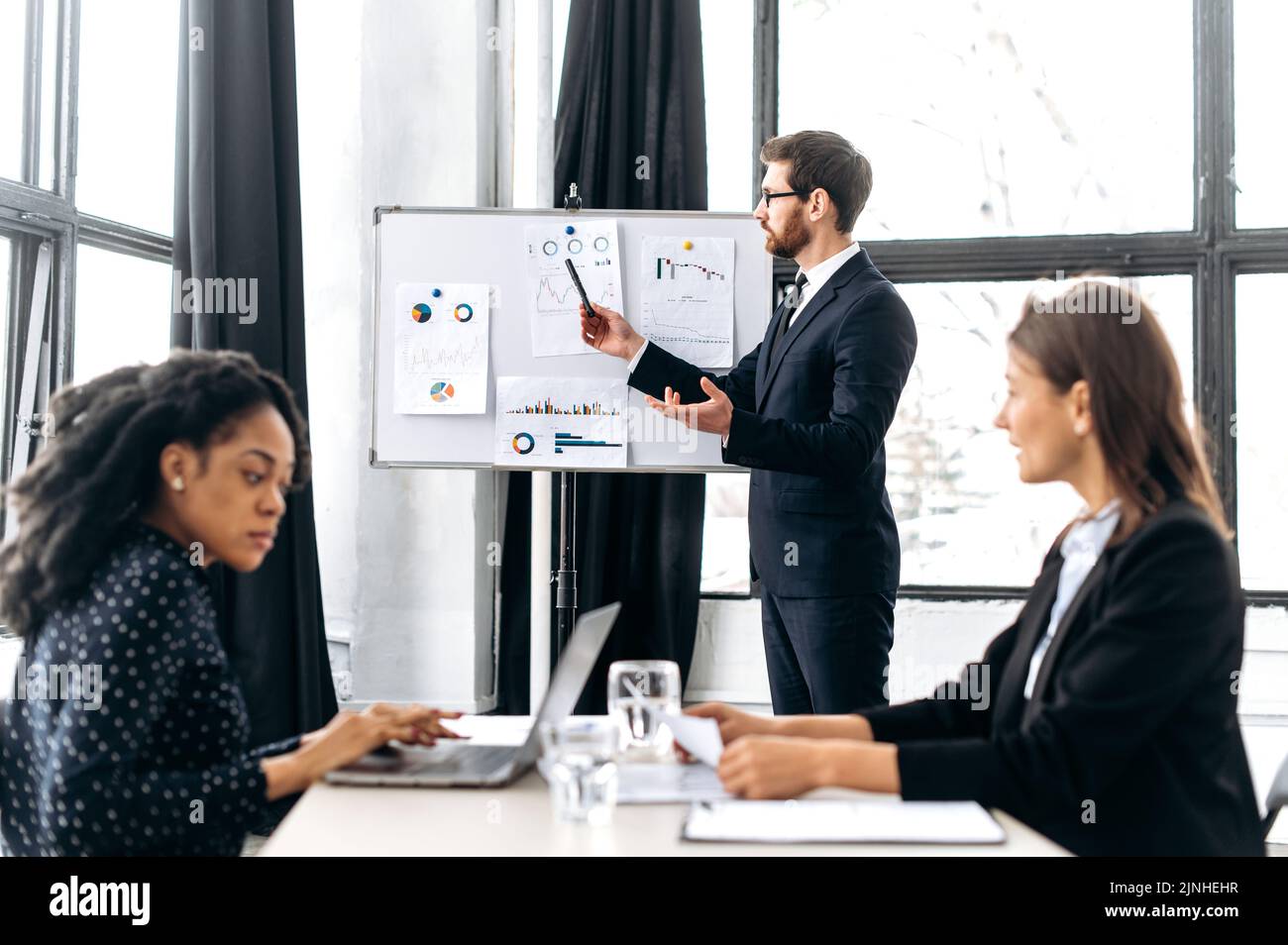 Influential Caucasian attractive male ceo, holding group brainstorm ...