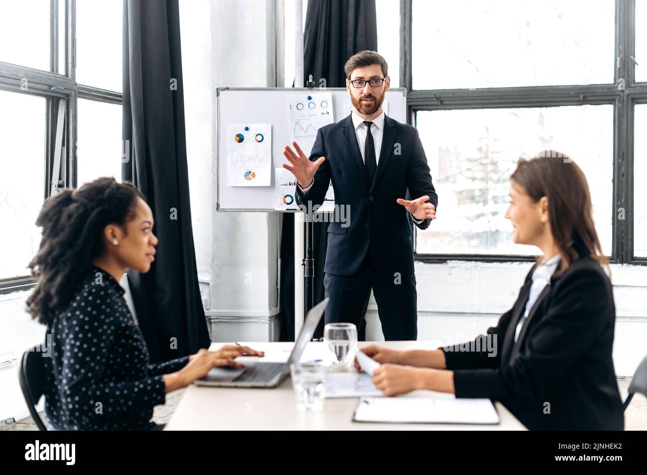 Elegant Caucasian intelligent male boss, holding group brainstorm with ...