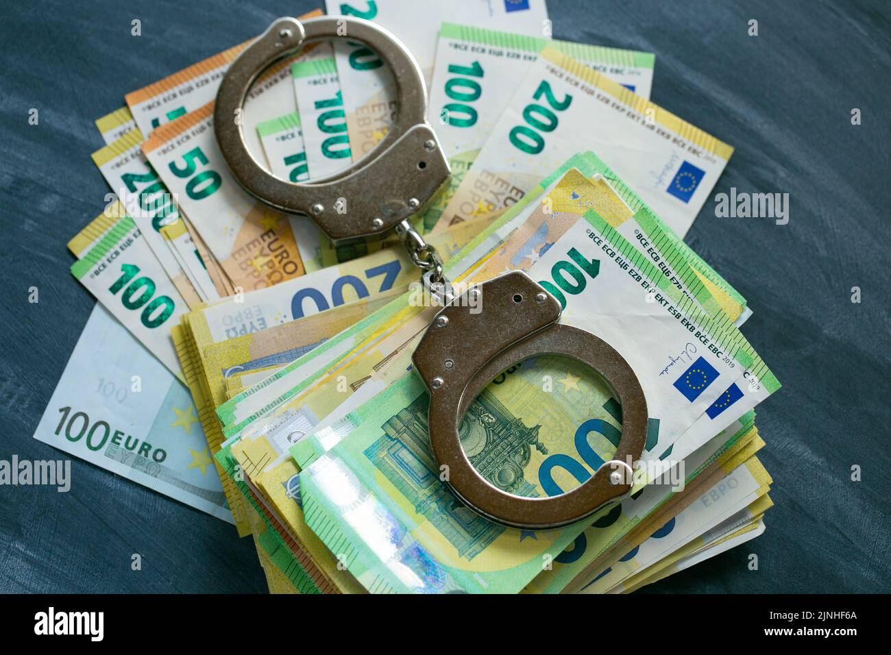 economic crimes.Handcuffs on euro bills background.Arrest on bank ...