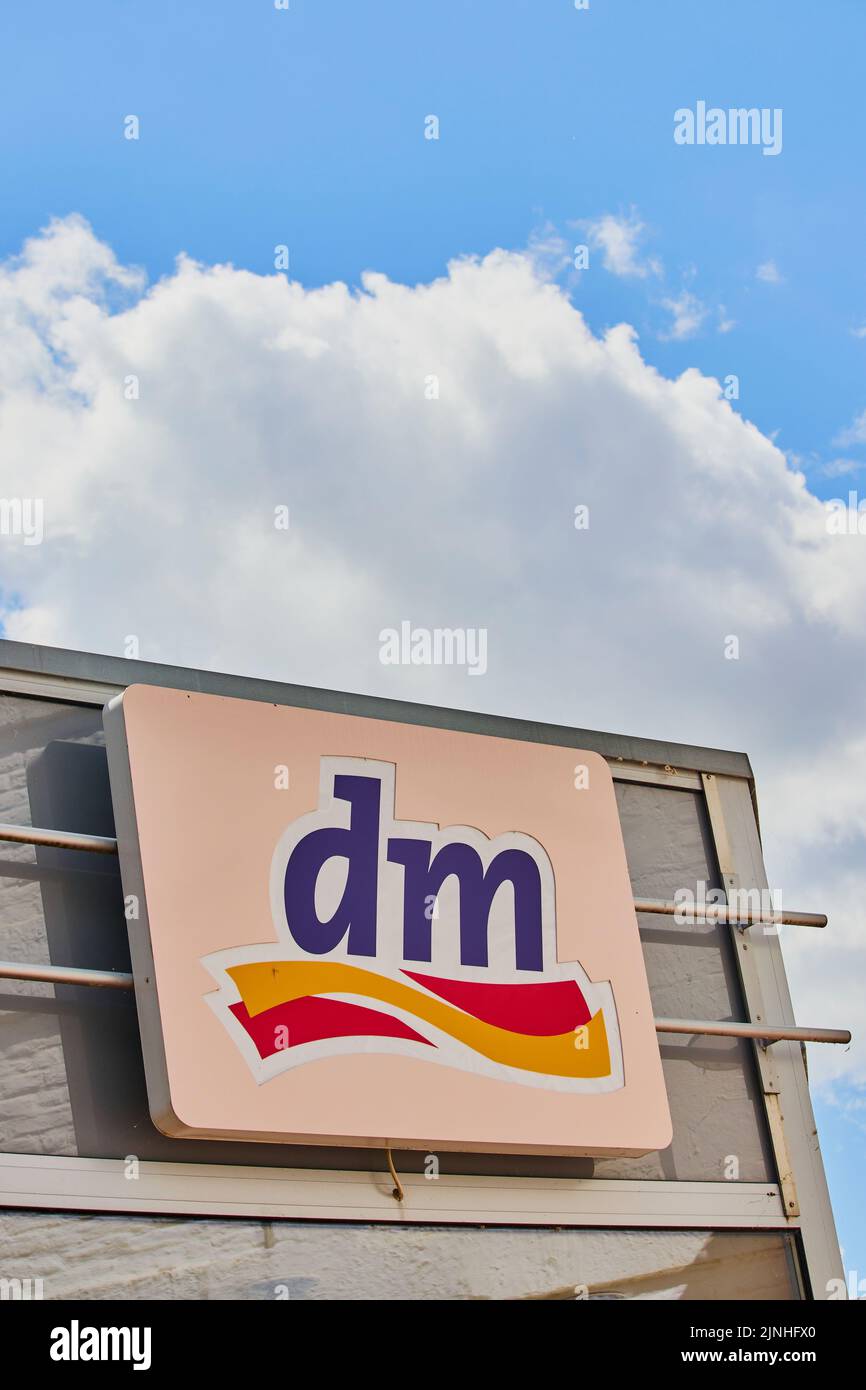 A billboard of dm logo against a background of sky and clouds Stock ...