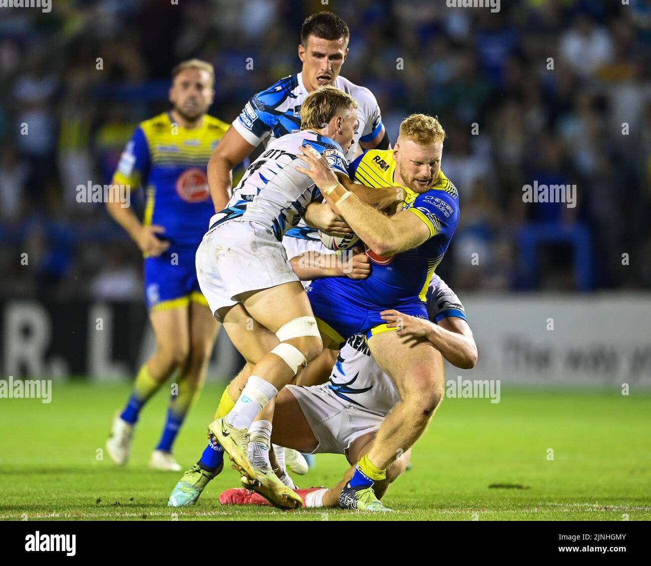 Joe Bullock #15 of Warrington Wolves is tackled by Oliver Ashall-Bott ...