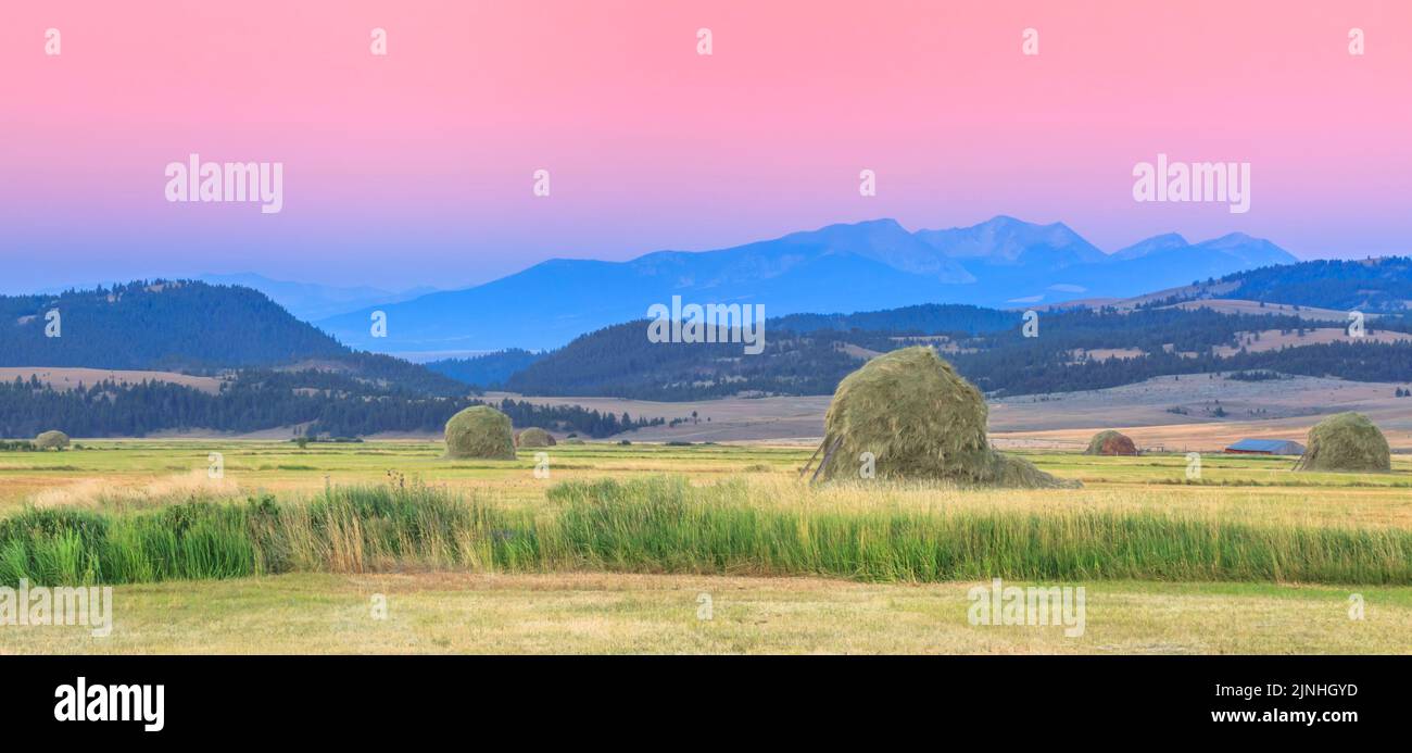 panorama of a pre-dawn sky over haystacks and the flint creek range ...