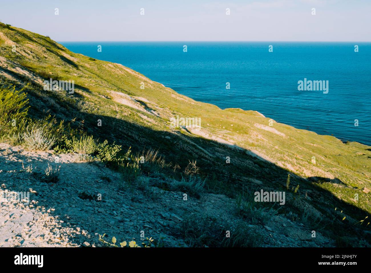 View of steep green rocky slope Stock Photo - Alamy